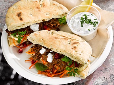 Slowcooked lamb pitta with za'atar slaw & a sesame carrot salad - Bidfood